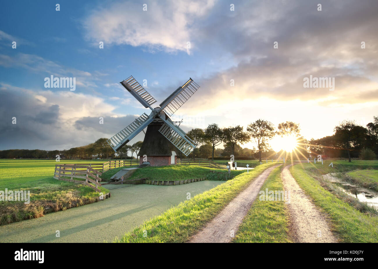 windmill, rural road and river at sunrise, Netherlands Stock Photo - Alamy