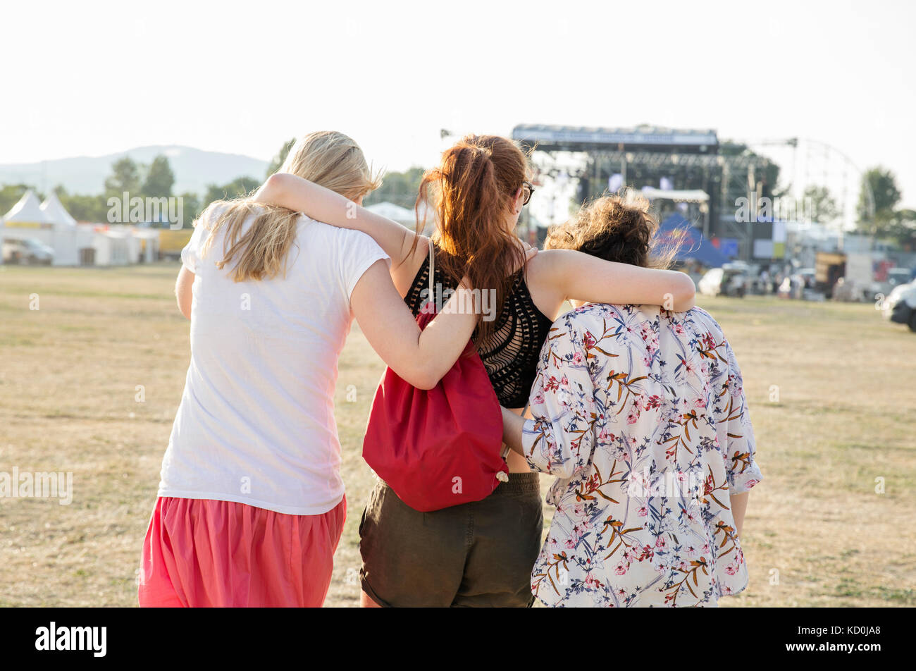 Three female friends at festival, rear view Stock Photo - Alamy