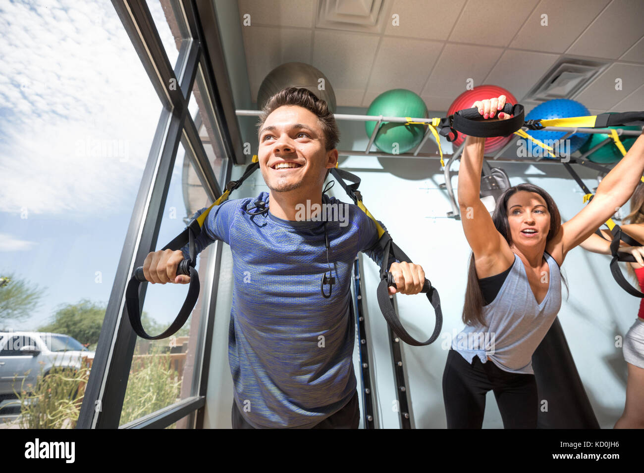 Friends training with resistance band in gym Stock Photo - Alamy