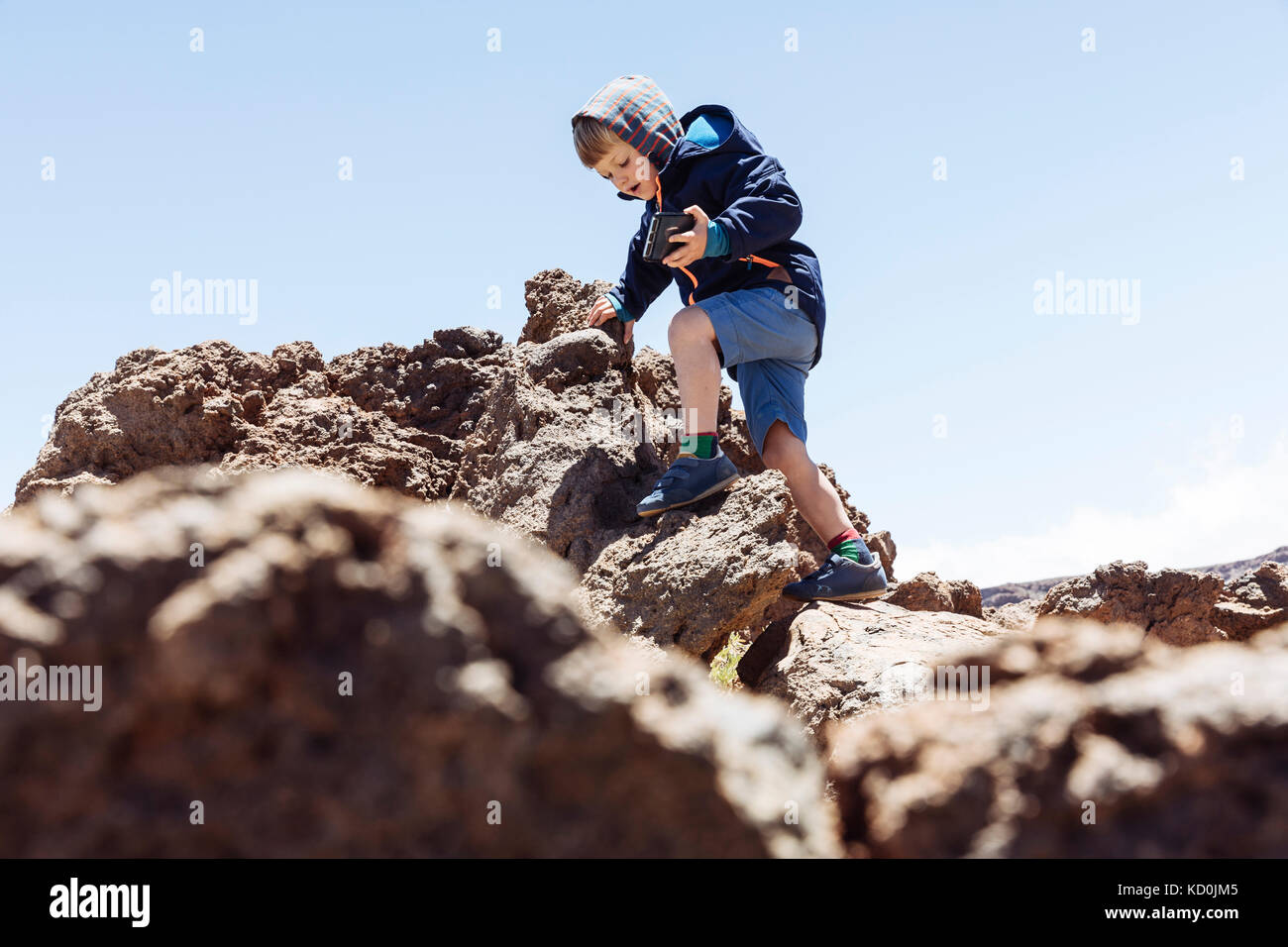 Boy clambering up rocks at Mount Teide, Tenerife, Canary Islands Stock ...