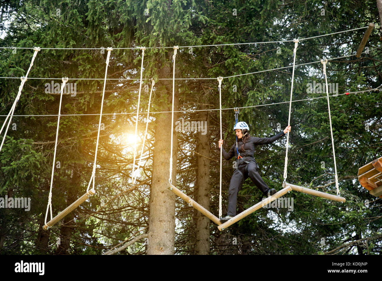 Teenage girl on high rope course Stock Photo - Alamy