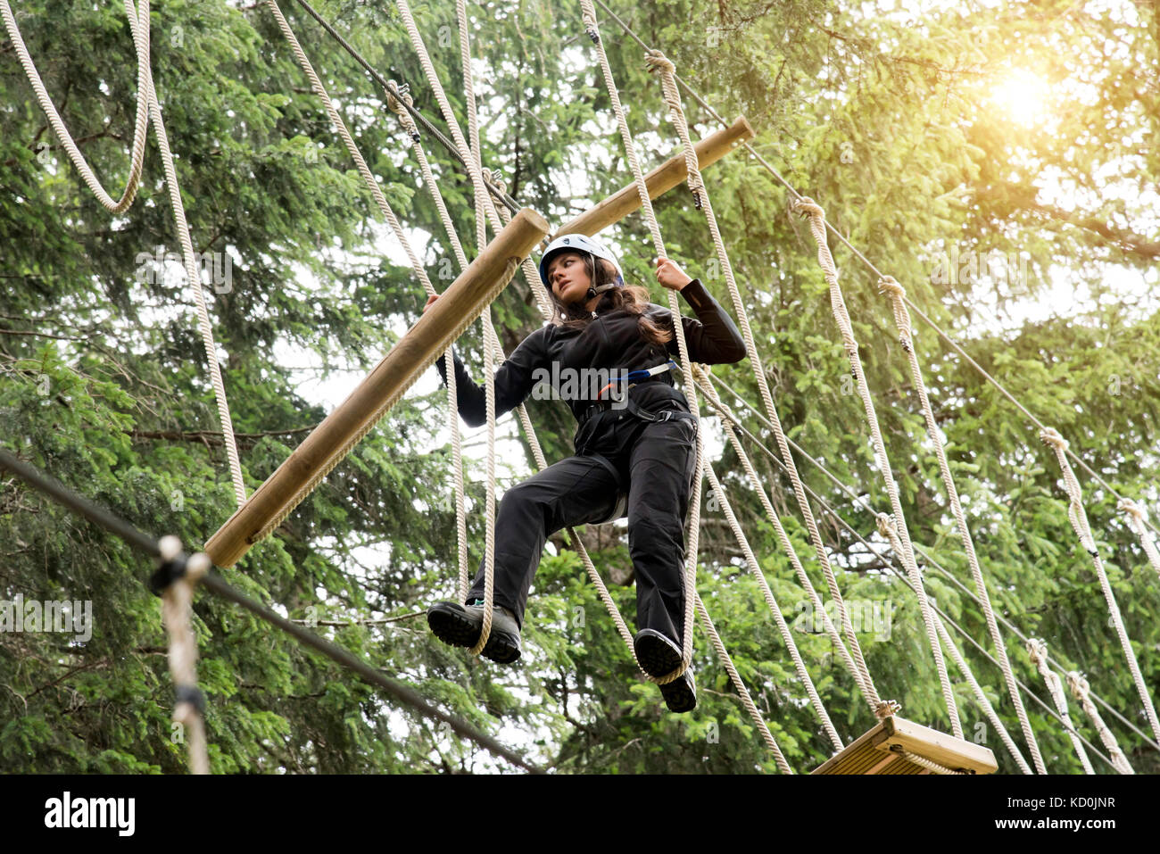 Teenage girl on high rope course Stock Photo - Alamy