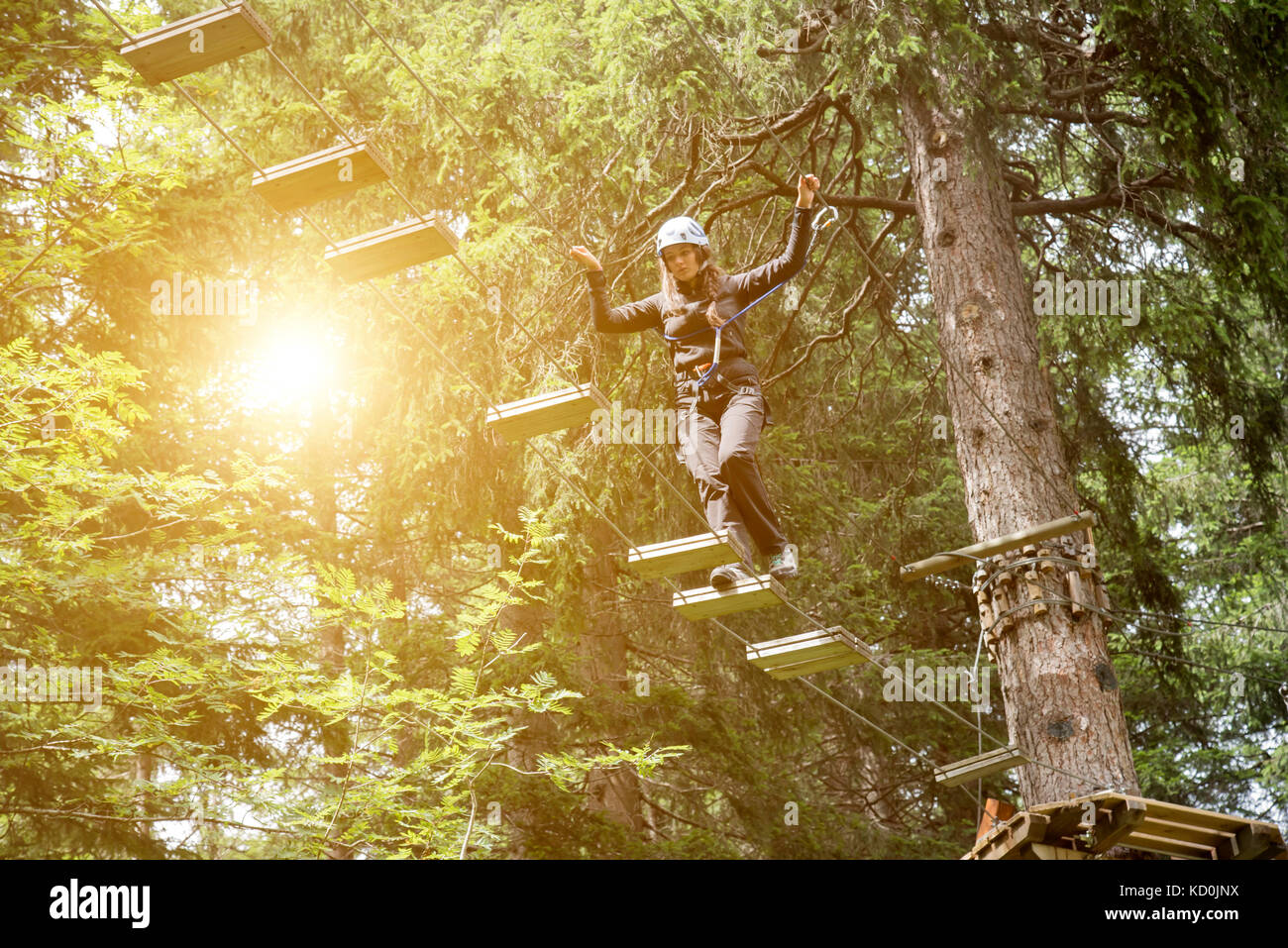 Teenage girl on high rope course Stock Photo - Alamy