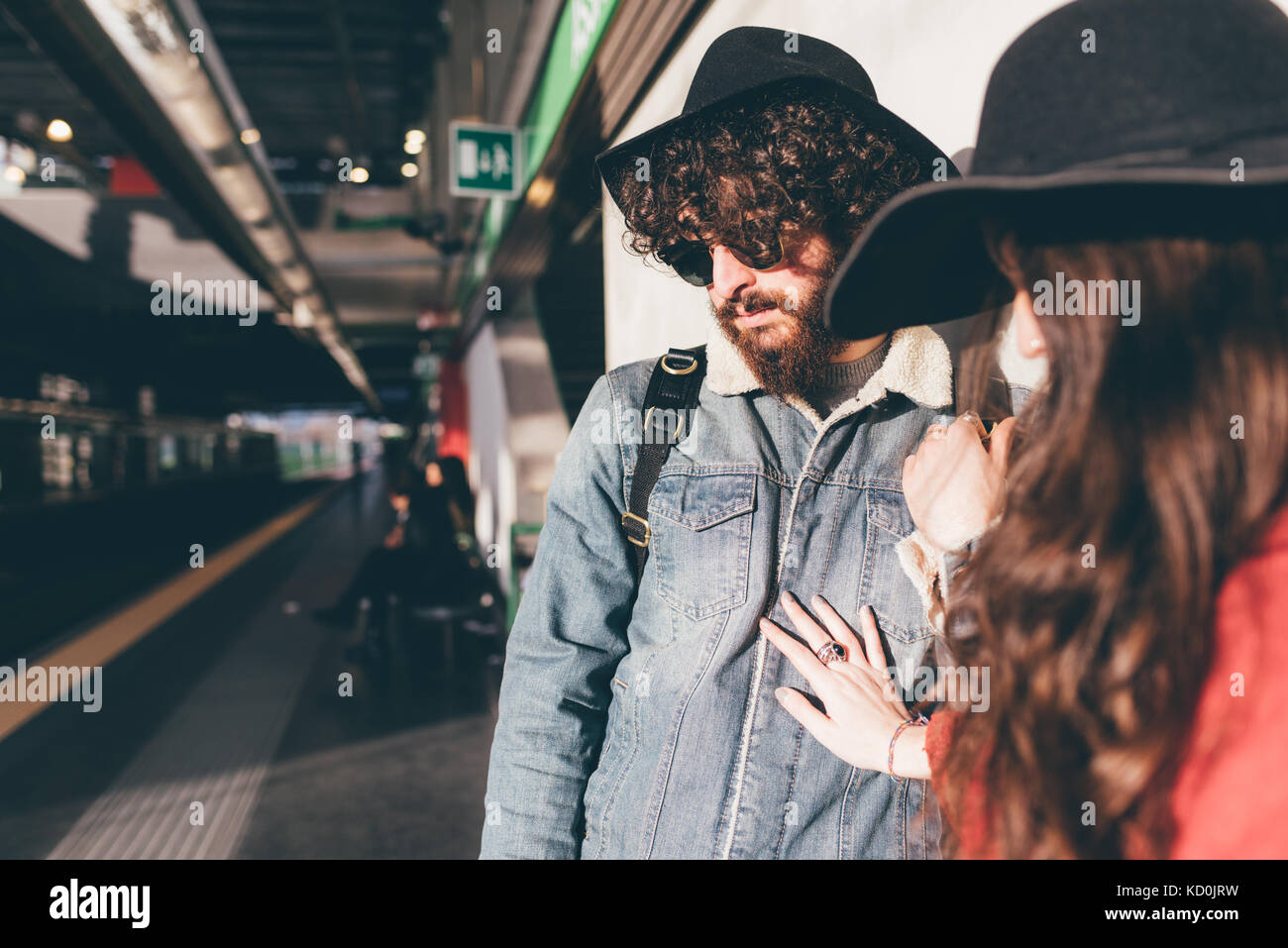 Young couple standing on train platform Stock Photo - Alamy