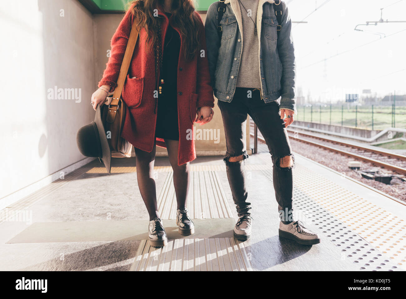 Portrait of young couple on train platform, low section Stock Photo - Alamy
