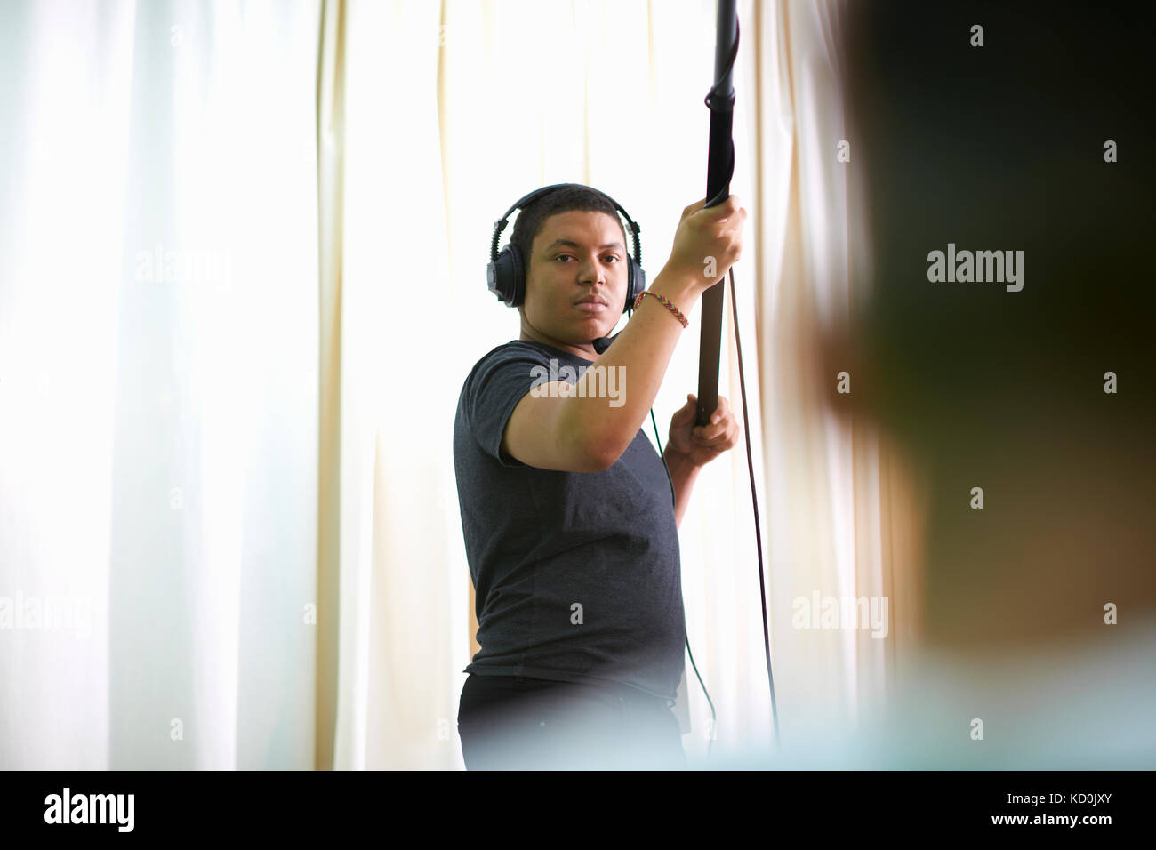 Young male college student recording in TV studio Stock Photo - Alamy