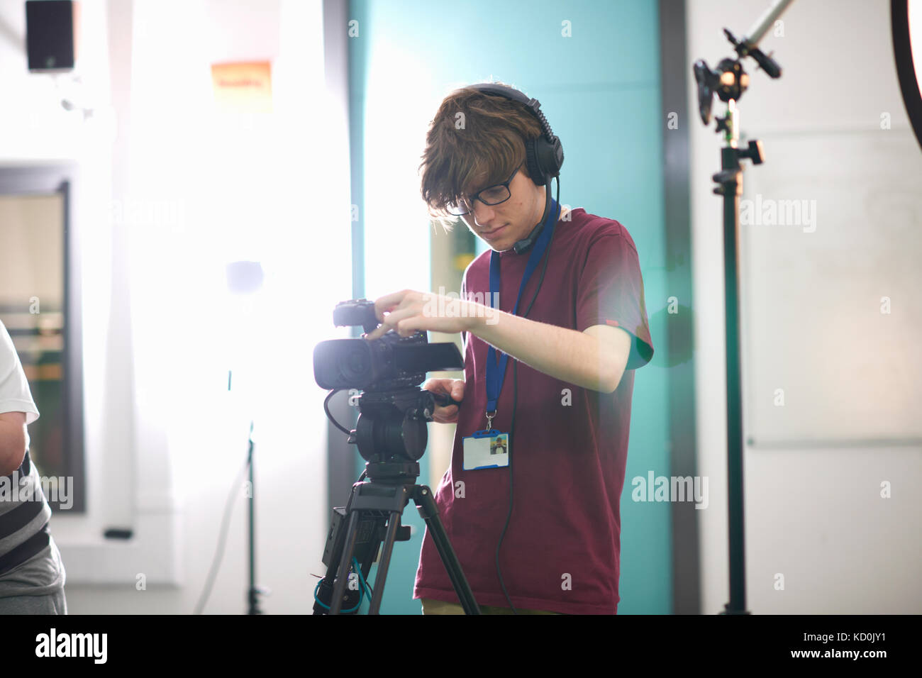 Young male college student filming in TV studio Stock Photo - Alamy