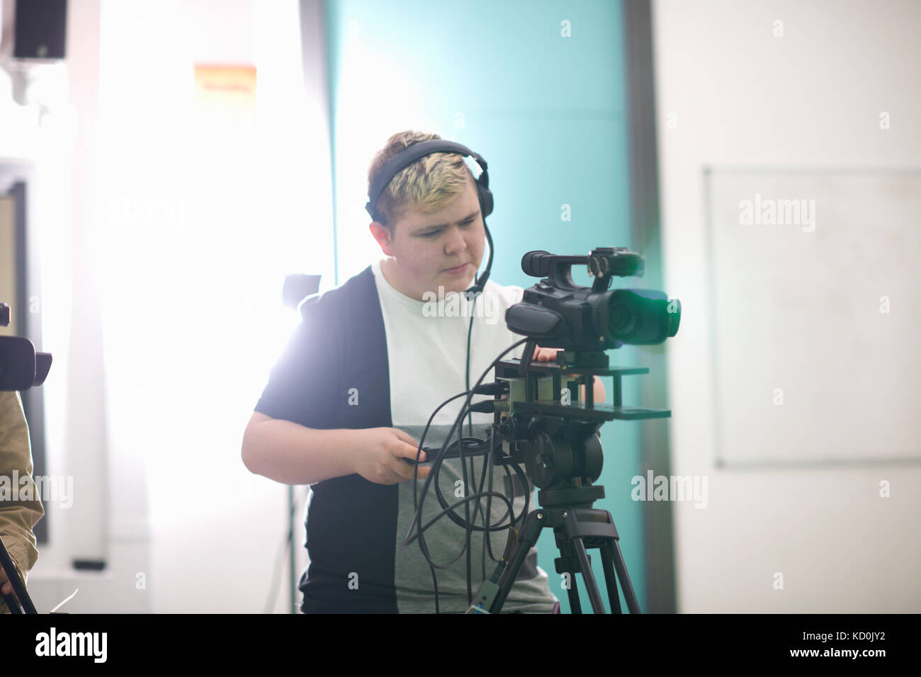Young male college student filming in TV studio Stock Photo - Alamy