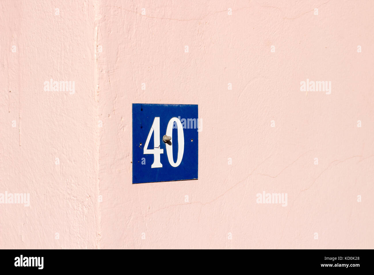 address sign number at the exterior wall of a pink house number 40 ...