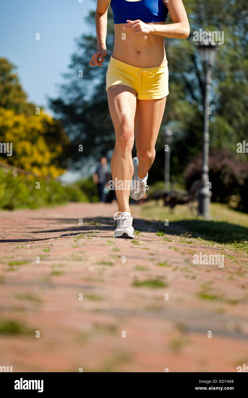 Jogger legs in park Stock Photo - Alamy