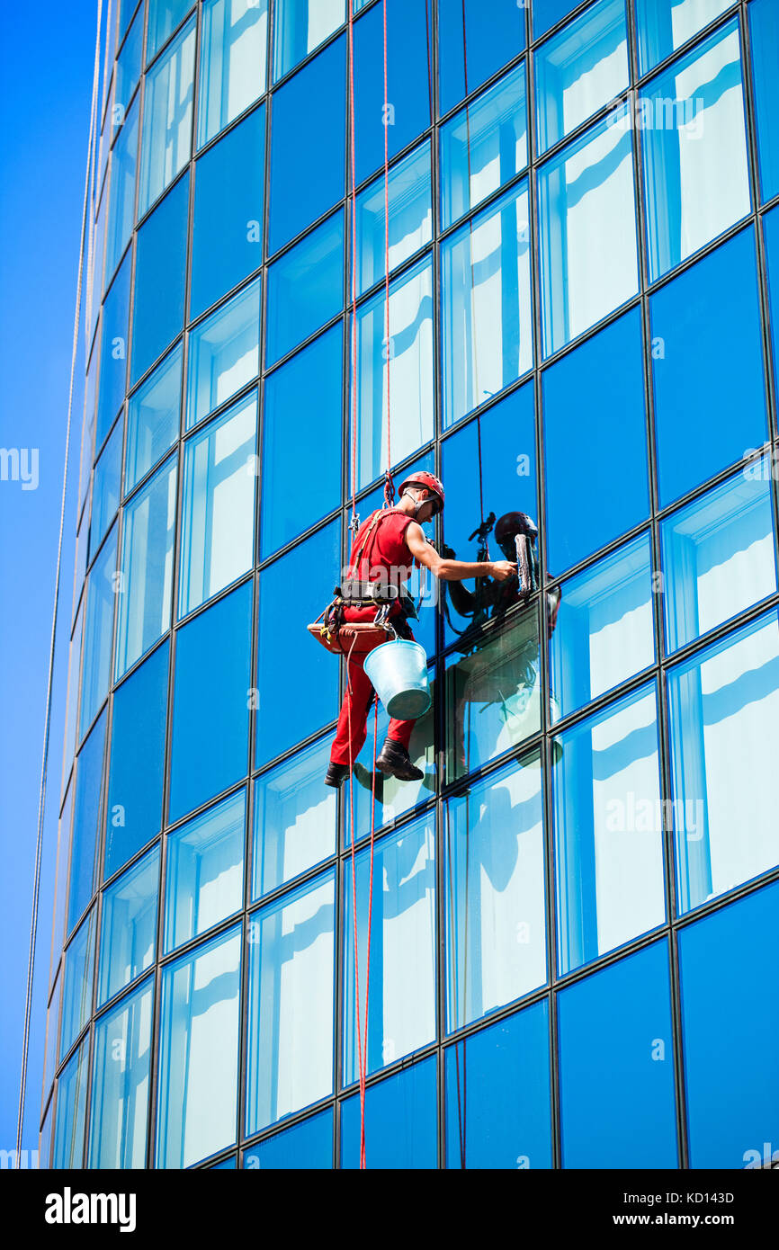 Window washer cleaning windows from outside Stock Photo - Alamy