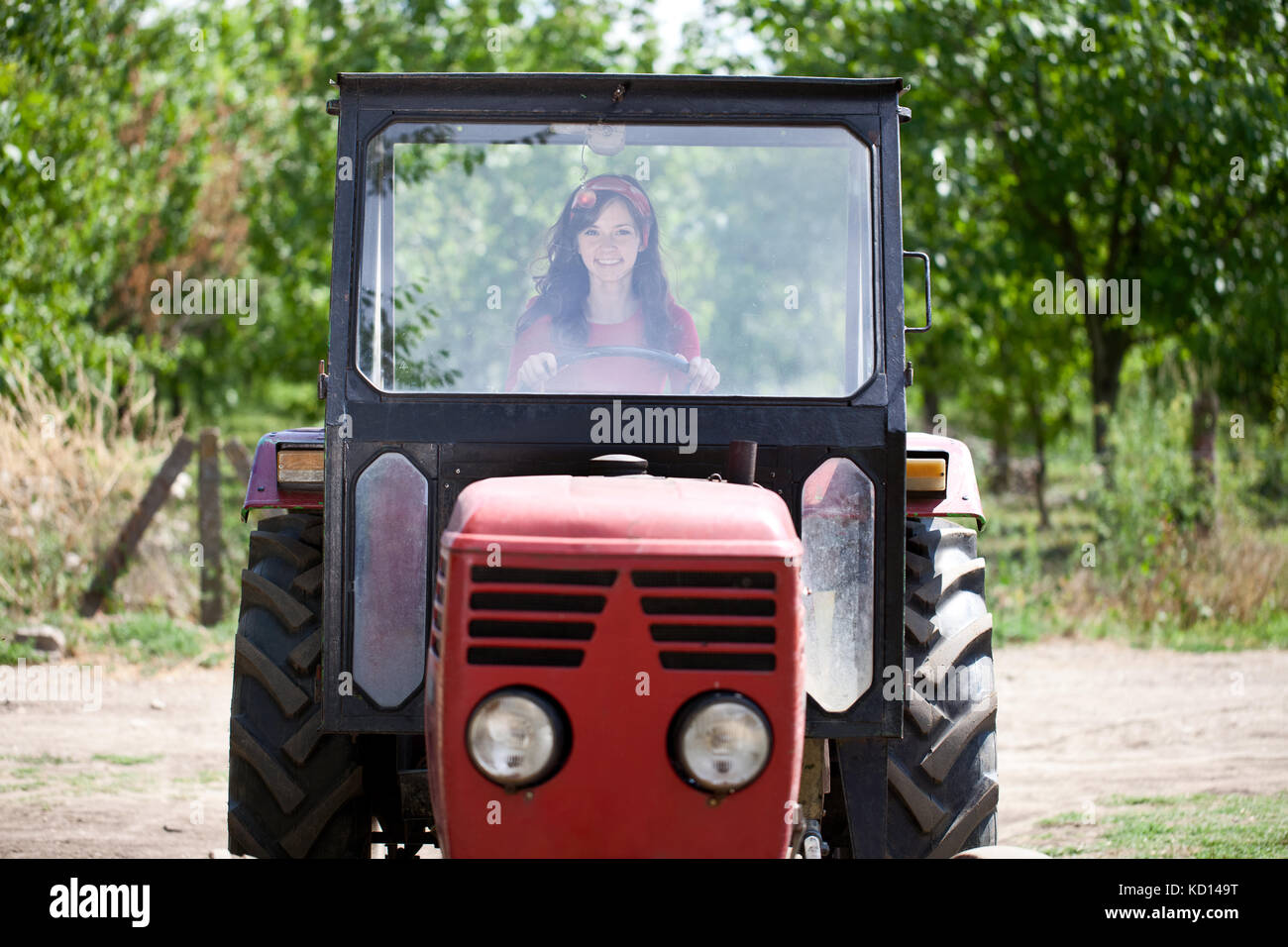 Young cute woman driving tractor Stock Photo - Alamy