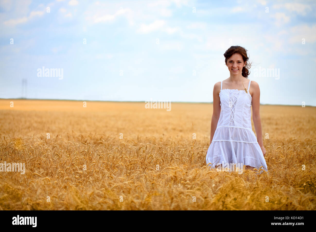 young woman in white dress standing in wheat field Stock Photo - Alamy