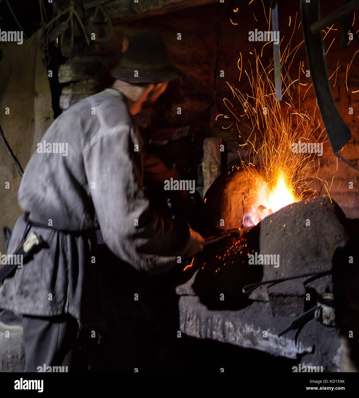 The smith is working near the burning furnace Stock Photo - Alamy