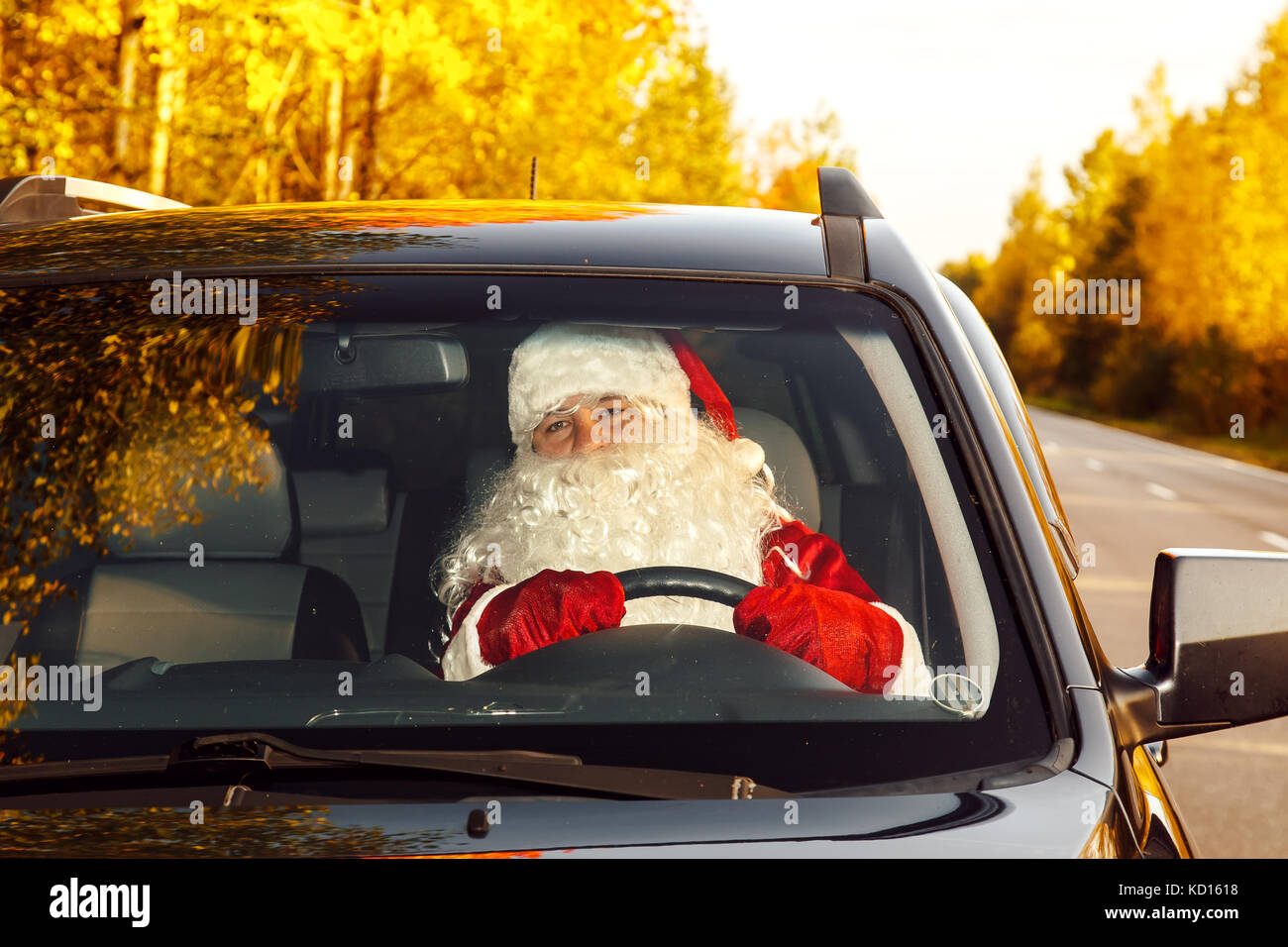 Authentic Santa Claus. Santa Claus drives a car through the autumn ...