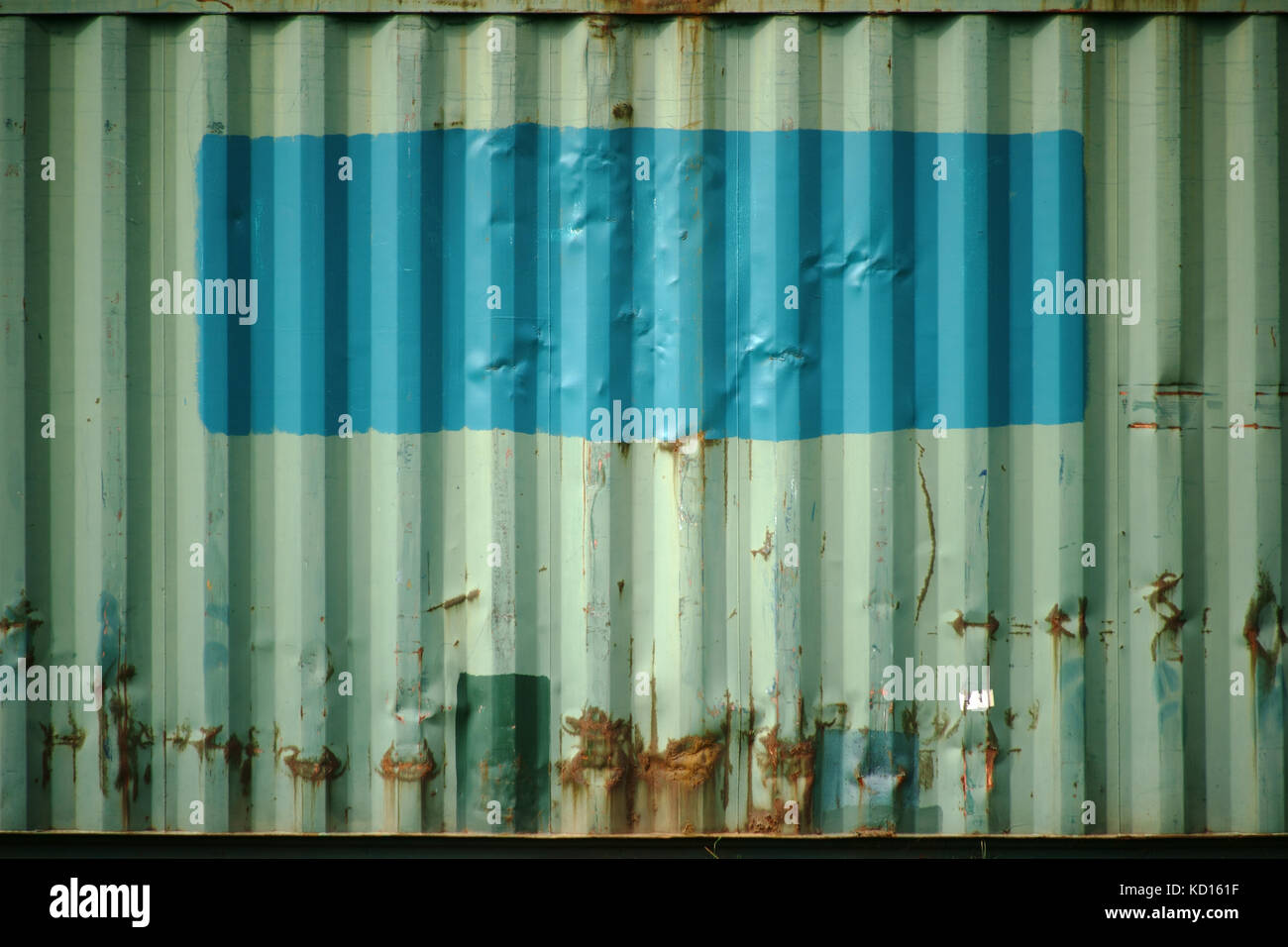 The side view of an old rusted cargo container with reworked and ...