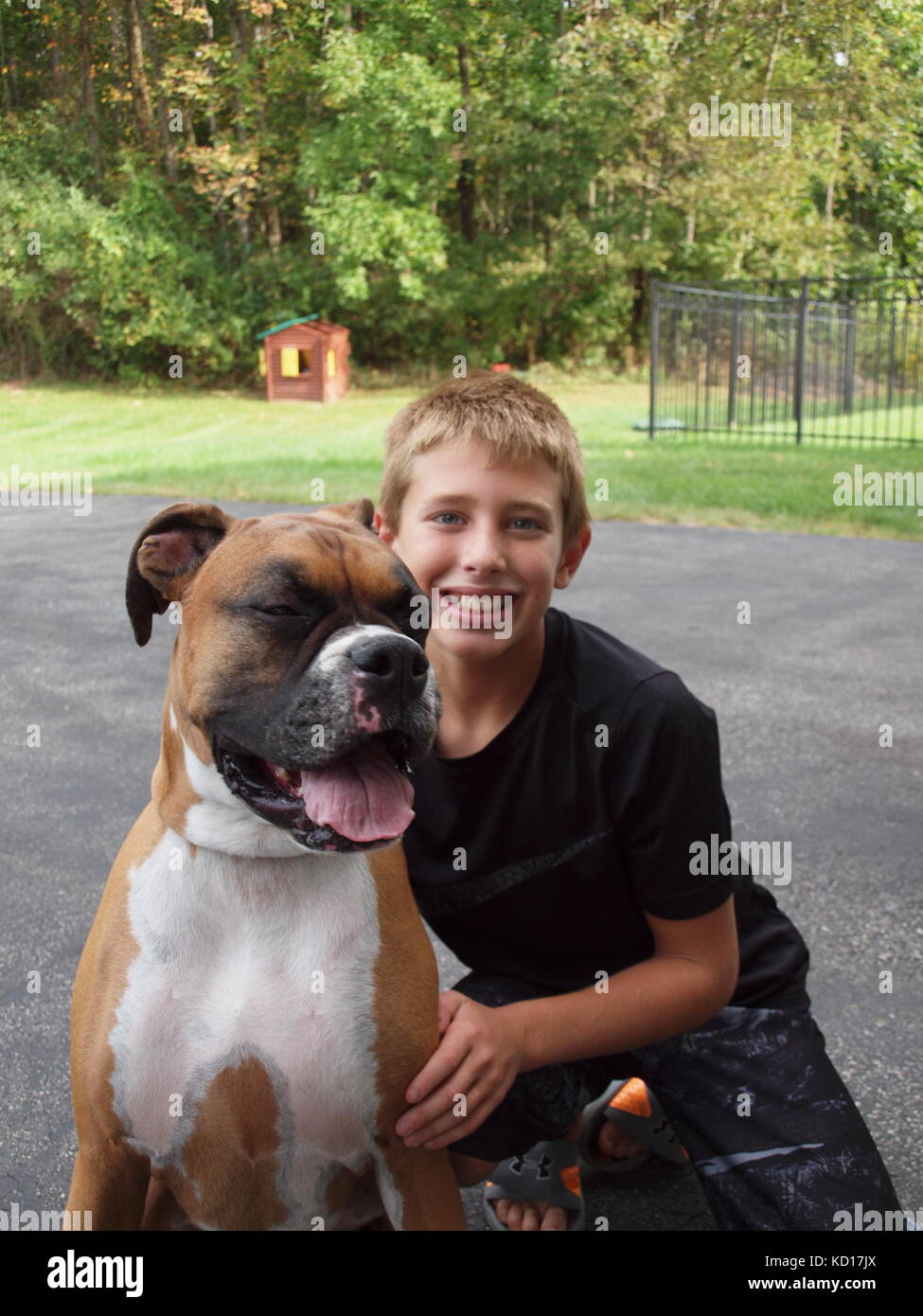 Smiling boy and his grinning Boxer Stock Photo - Alamy