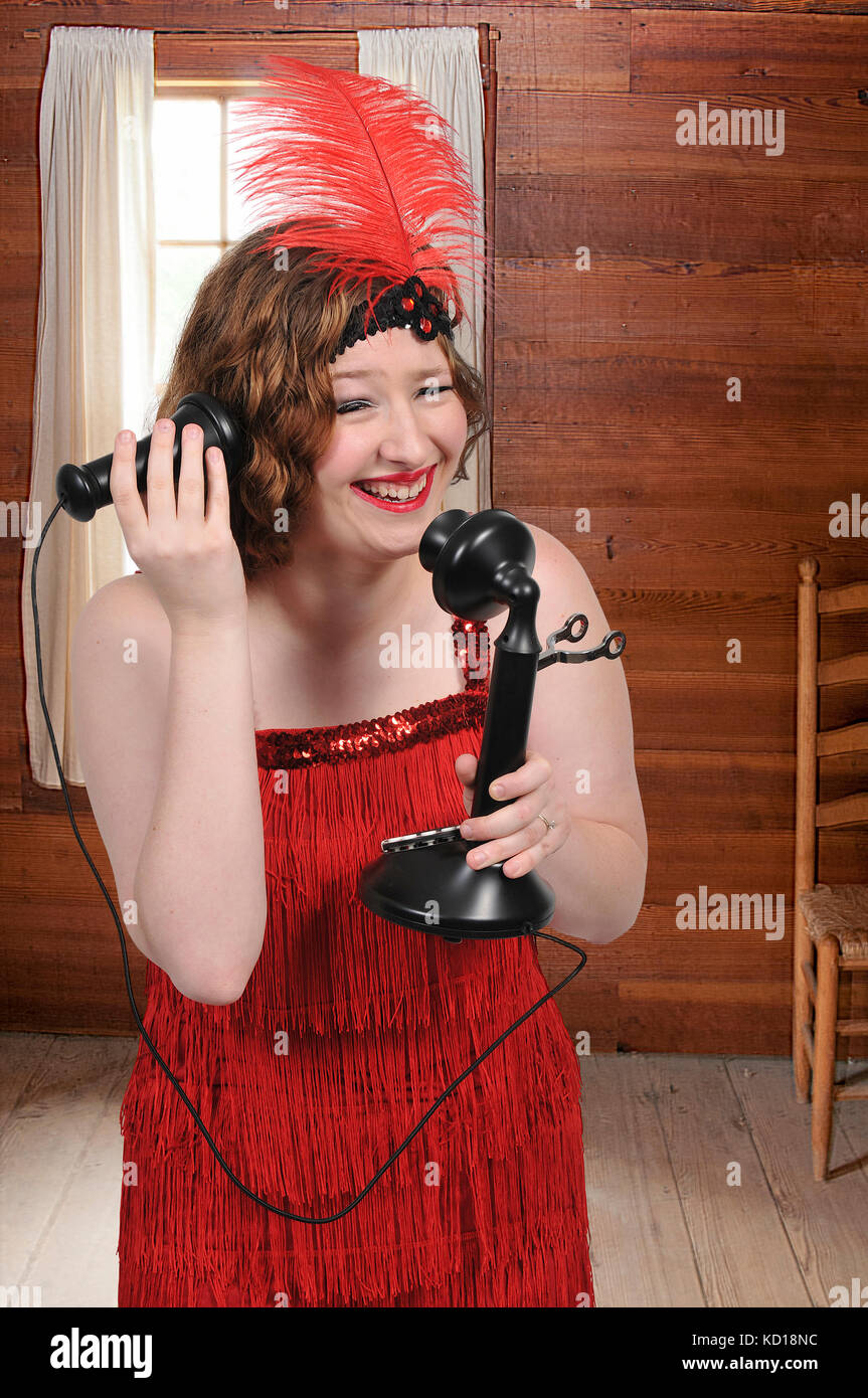 Woman using an old timey vintage candlestick phone Stock Photo - Alamy