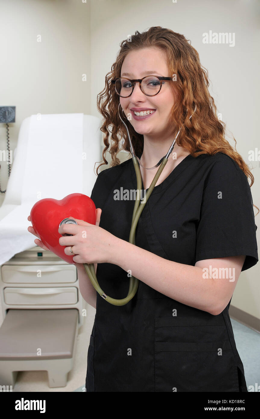 Beautiful young woman cardiologist doctor holding a heart Stock Photo ...