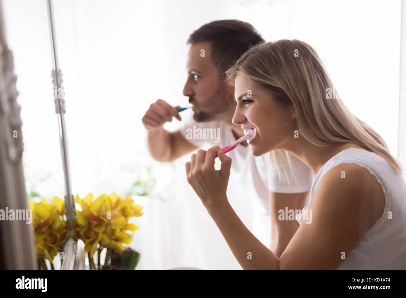 Attractive couple washing teeth in morning together Stock Photo - Alamy
