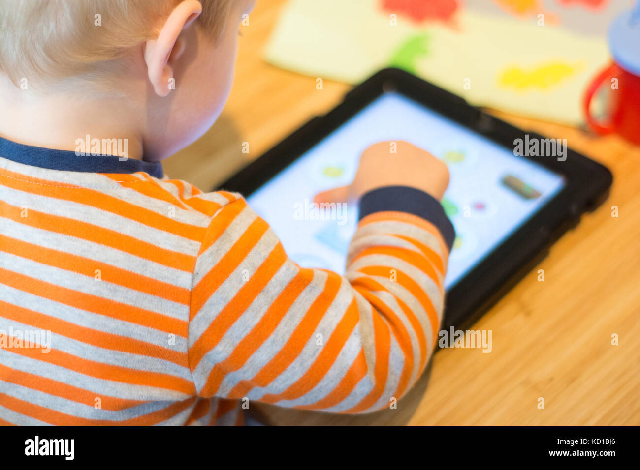 Child using a touch screen tablet to play learning game Stock Photo - Alamy
