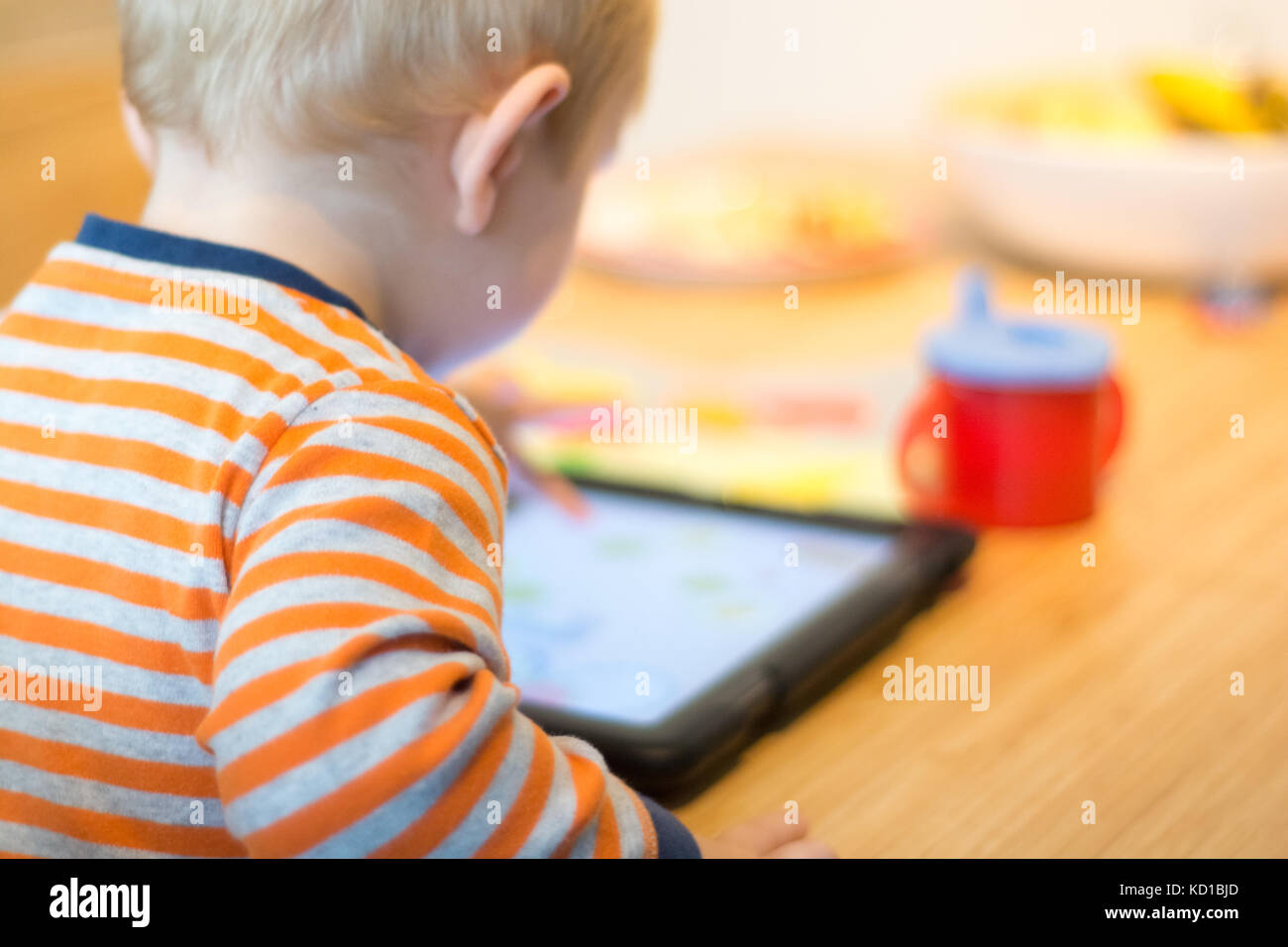 Child using a touch screen tablet to play learning game Stock Photo - Alamy