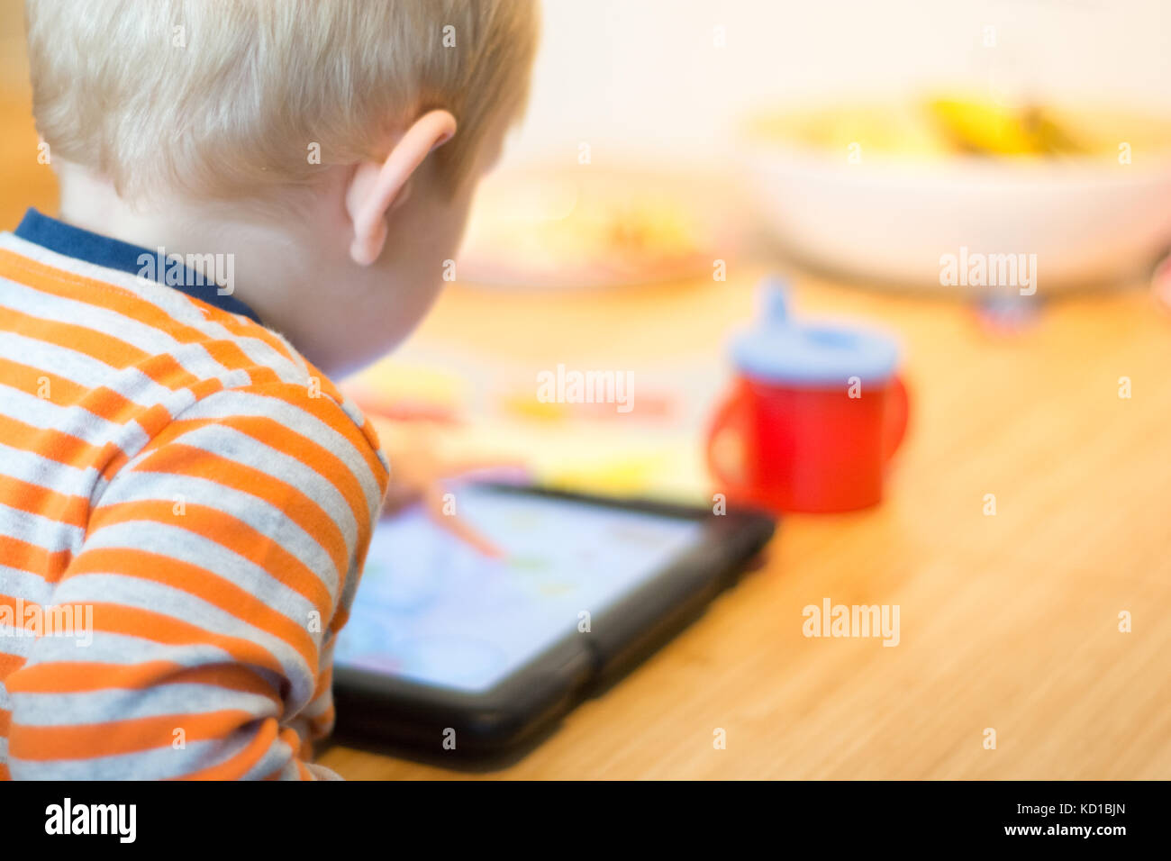 Child using a touch screen tablet to play learning game Stock Photo - Alamy