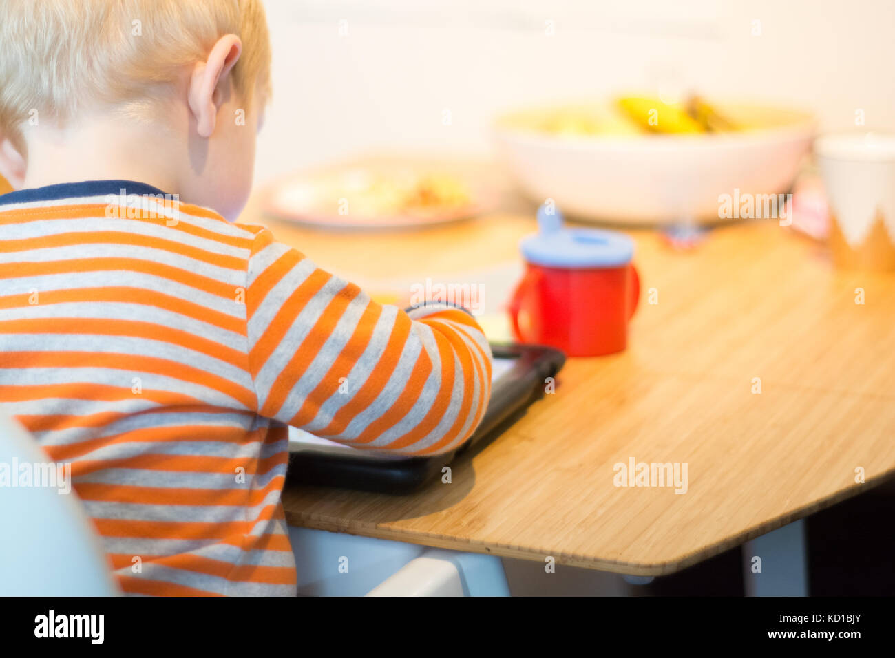 Child using a touch screen tablet to play learning game Stock Photo - Alamy