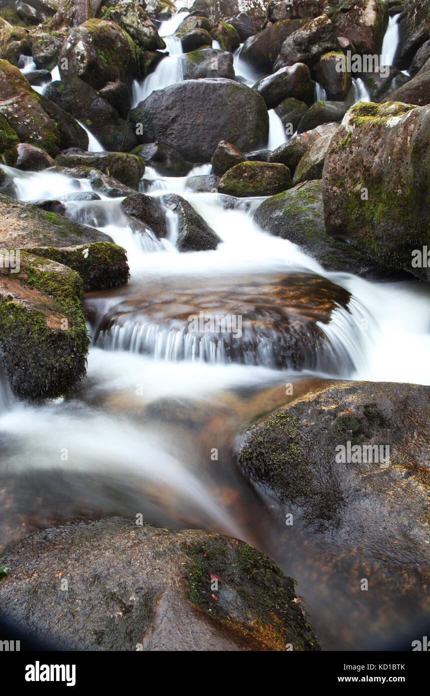 water flowing over rocks in Becka Brook at Becky Falls, Manaton, Devon ...