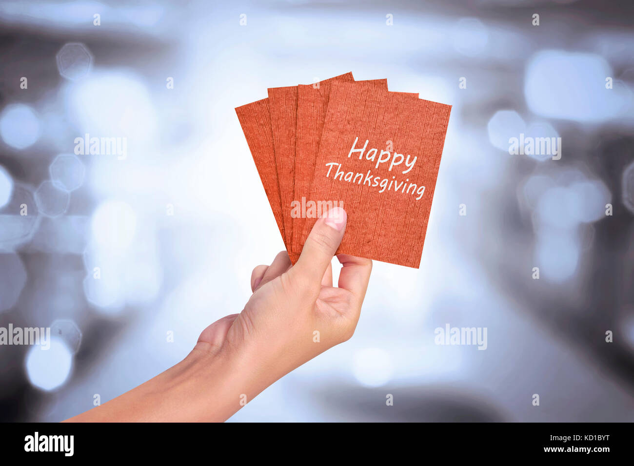 Human hand holding Happy Thanksgiving card against abstract background ...