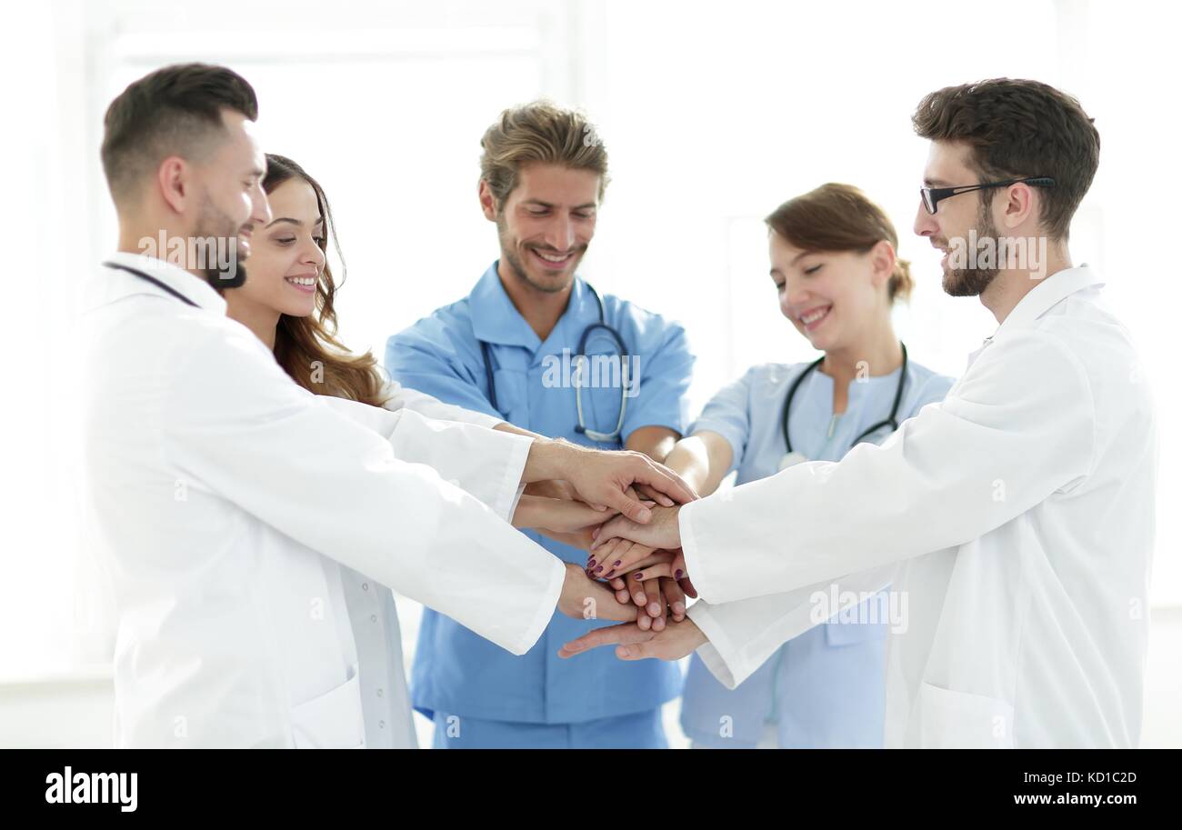 Doctors and nurses stacking hands. concept of mutual aid Stock Photo ...