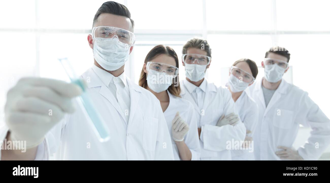 background image is a group of medical workers working with liquids in ...