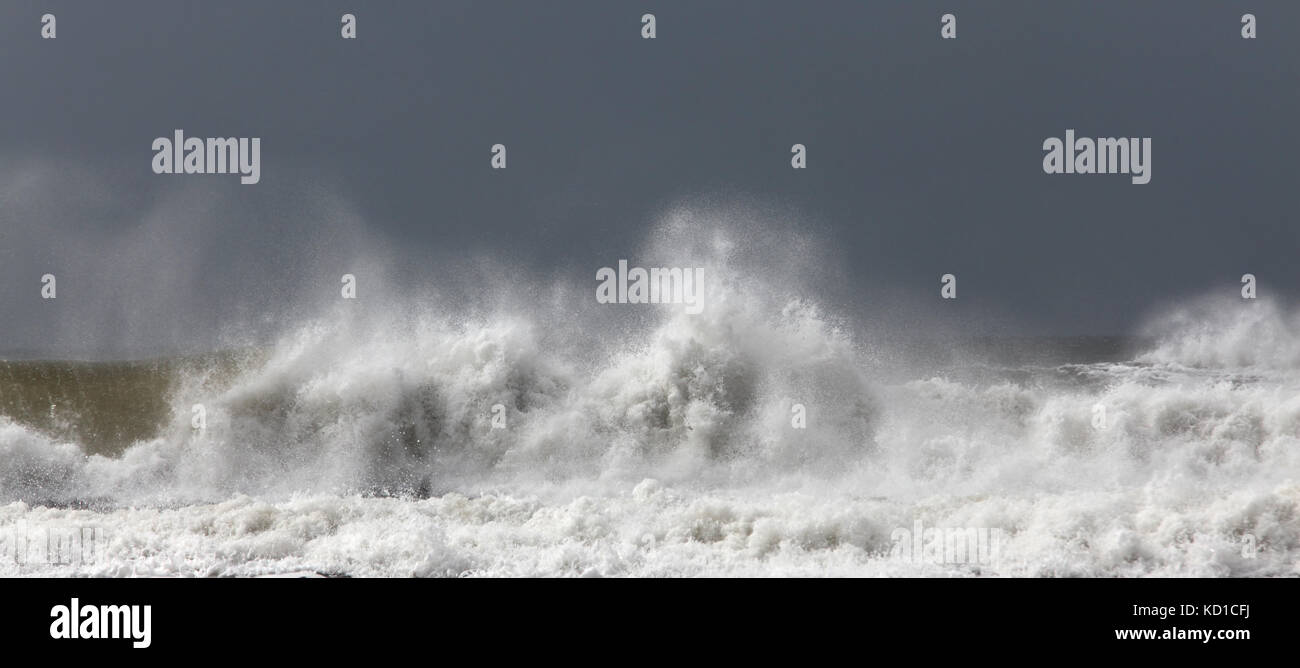 Waves crashing onto beach Stock Photo - Alamy