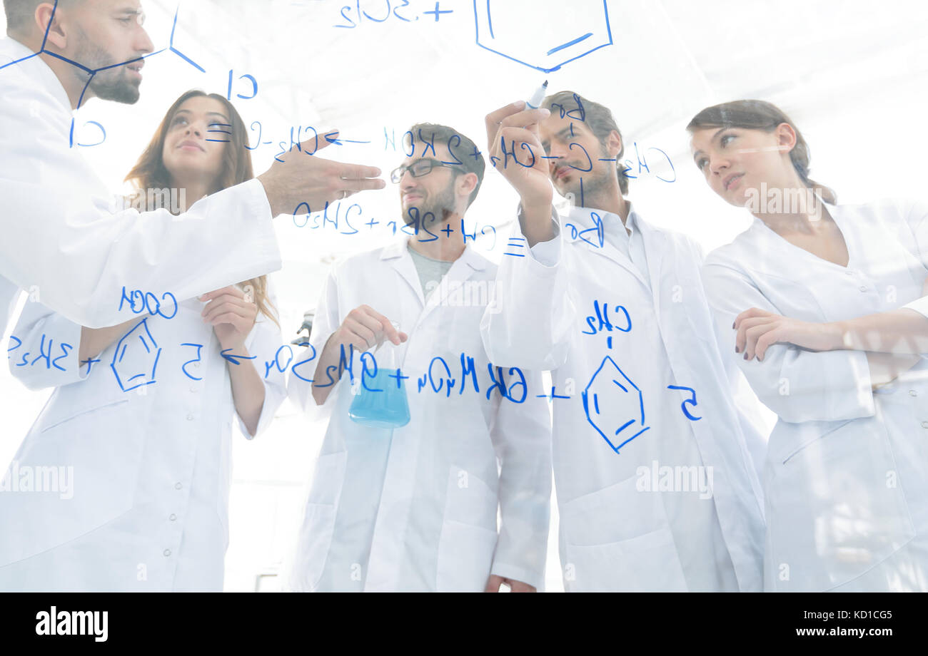 view through the transparent Board. a group of scientists analyze ...