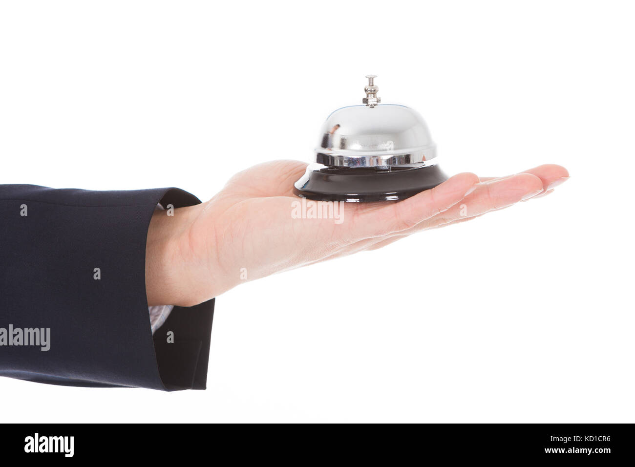 Close-up Of Person's Hand Holding Service Bell Over White Background ...