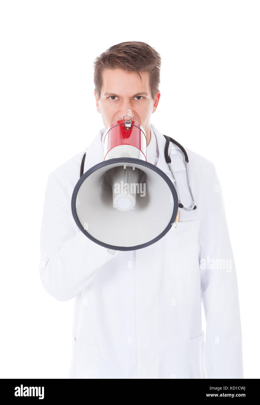 Male Doctor Shouting Through Megaphone Over White Background Stock ...
