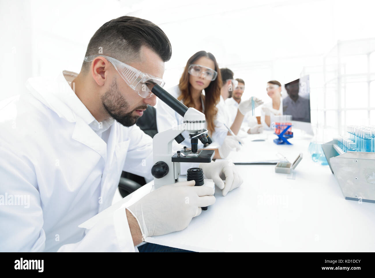 researcher looking into a microscope in a modern laboratory Stock Photo ...