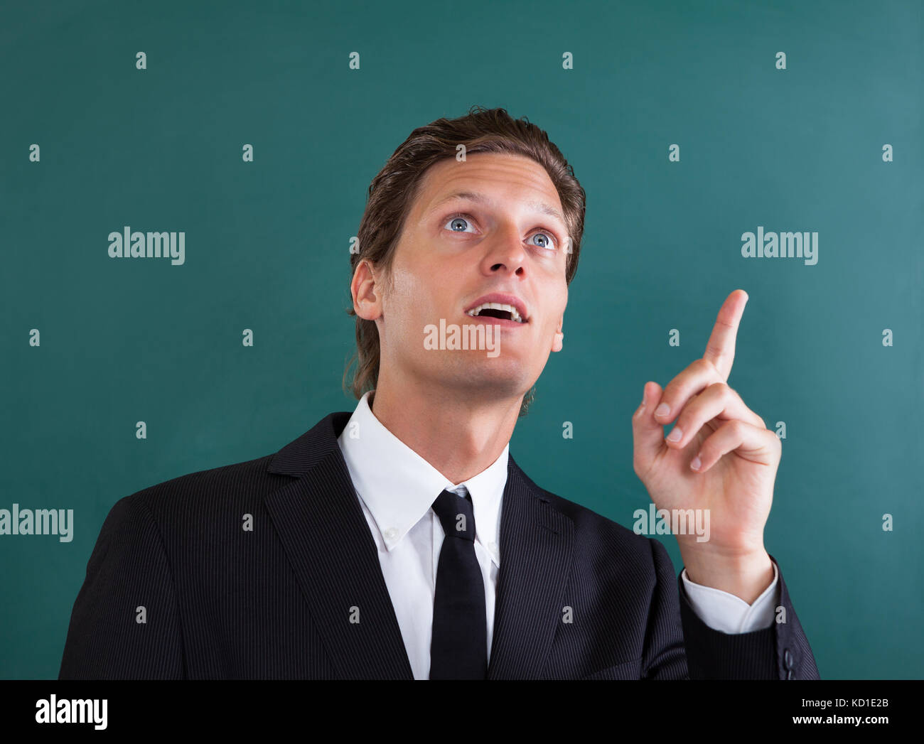 Portrait Of Young Contemplated Businessman Looking Up Stock Photo - Alamy