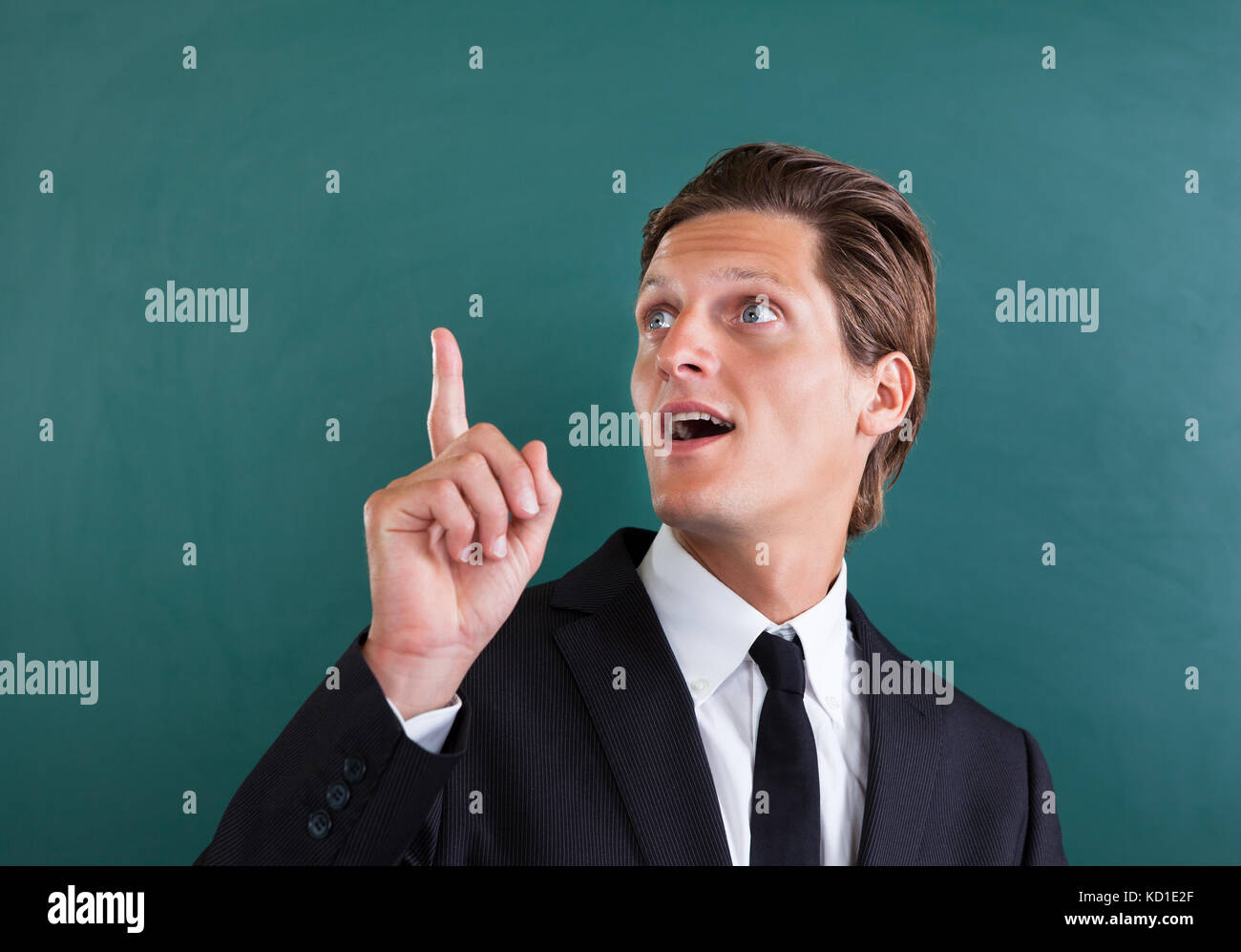 Portrait Of Young Contemplated Businessman Looking Up Stock Photo - Alamy