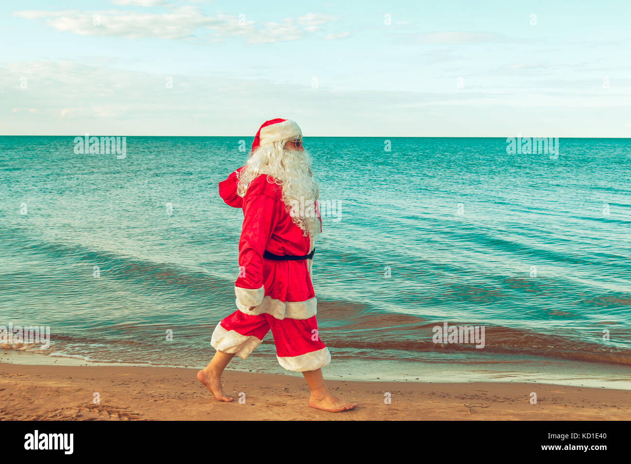 Santa Claus with a bag of gifts on the beach. The symbol of Christmas ...