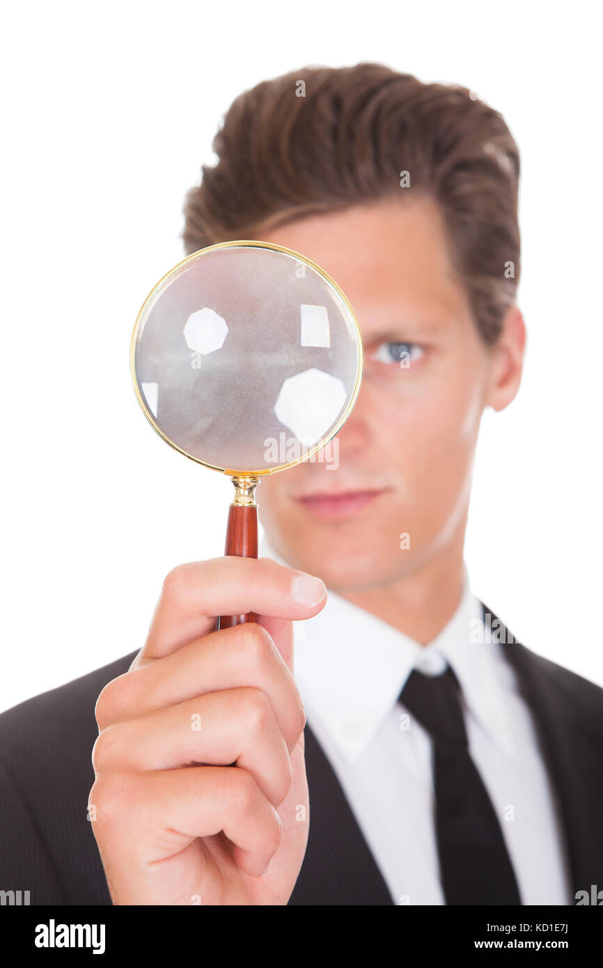 Businessman Holding Magnifying Glass In Front Of His Face Stock Photo ...