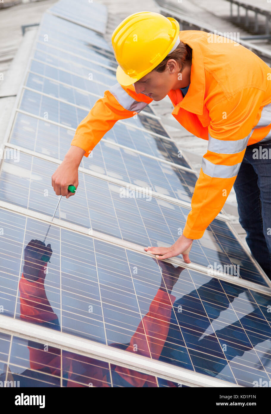 Male Engineer Adjusting Solar Panels With Work Tool Stock Photo - Alamy