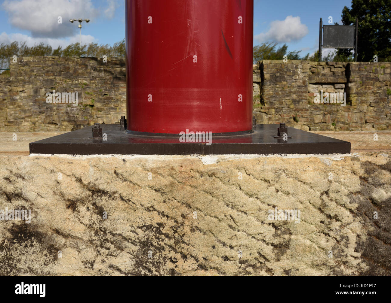 Steel plate at base of sculpture fixed to stone block with anchor bolt ...
