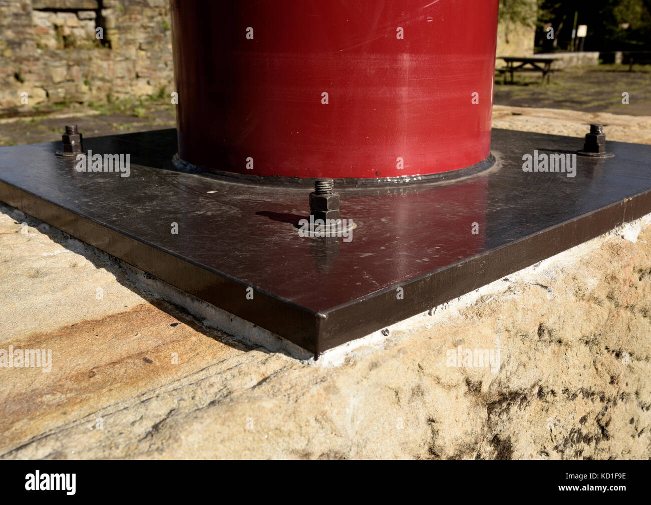 Steel plate at base of sculpture fixed to stone block with anchor bolt ...