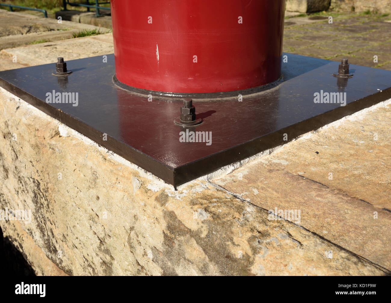 Steel plate at base of sculpture fixed to stone block with anchor bolt ...