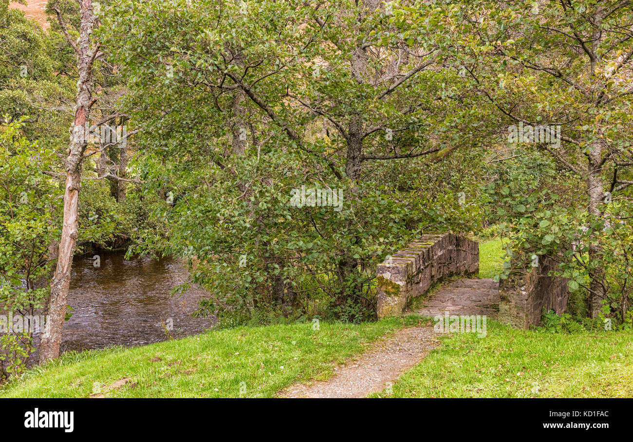An ornate and old bridge at the side of a river in Perthshire Scotland ...
