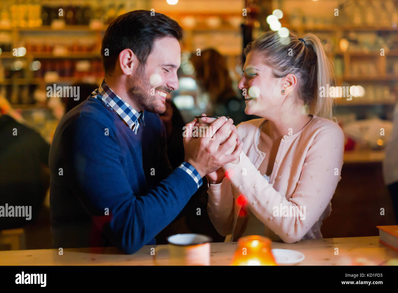 Happy couple talking at bar and having date Stock Photo - Alamy