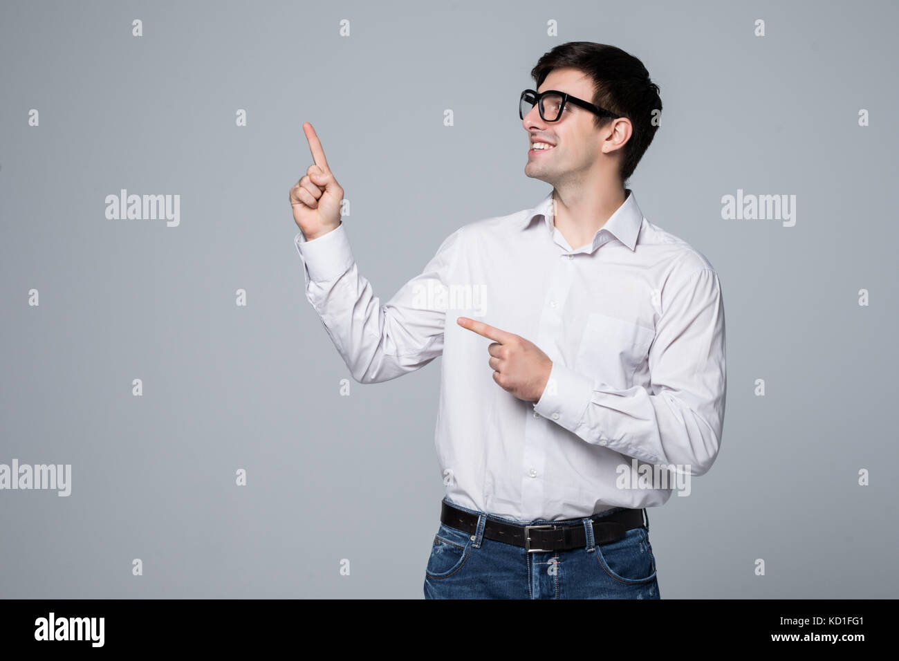 Portrait of a young businessman pointed his hand to left side. Isolated ...