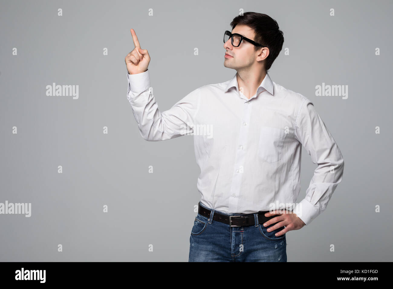 Businessman pointing copy space. Happy young man in shirt and tie ...