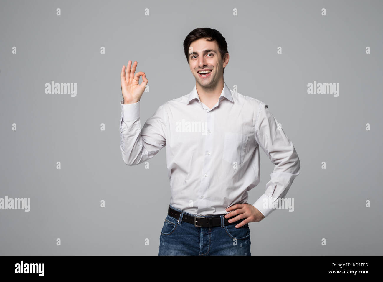 Happy okay man. Young handsome man in casual shirt gesturing okay and ...